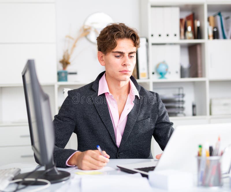 Intelligent Man Working on His Laptop in White Room Stock Image - Image ...