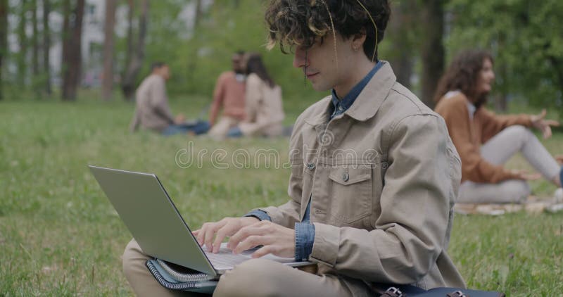 Intelligent Young Man Studying in Park Using Laptop Typing Concentrated ...