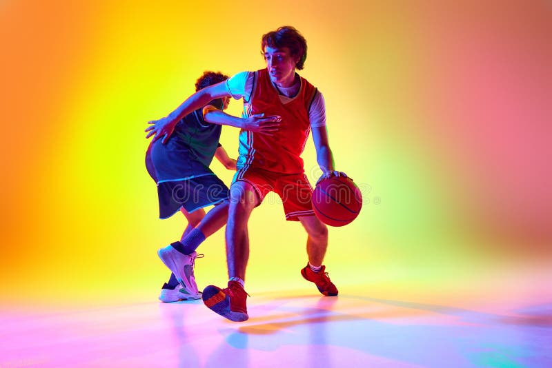 Intense Basketball Practice with Two Athletes in Neon Light Against ...