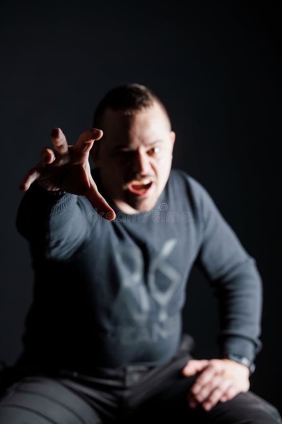 Intense Expression of Anger and Determination in Dark Setting Stock ...