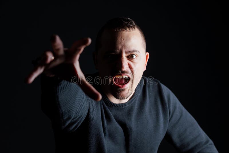 Intense Expression of Anger and Frustration in Dramatic Lighting Stock ...