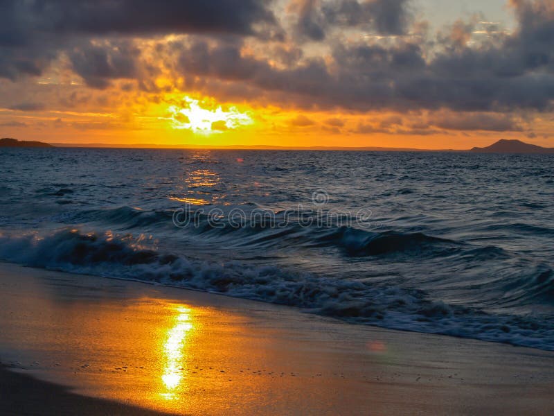 Intense Glow of Setting Sun through Clouds Over Horizon Stock Image ...