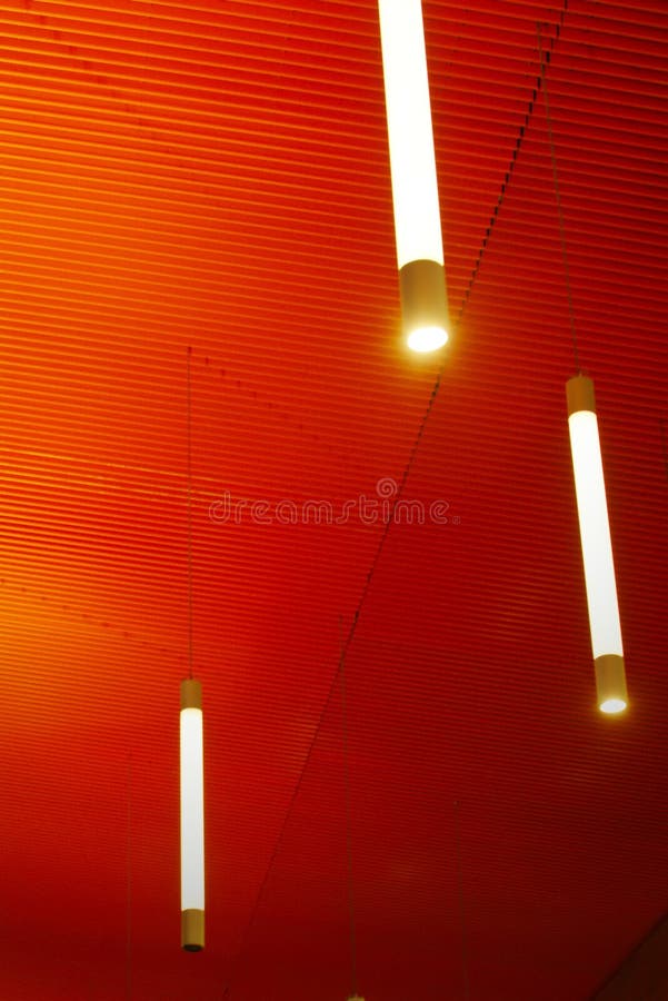 Intense Orange Ceiling with Vertical Light Tubes Stock Photo - Image of ...