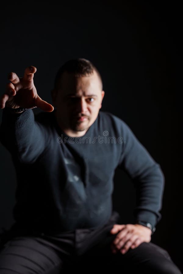 Intense Portrait of a Man Reaching Out in Dramatic Lighting Stock Image ...