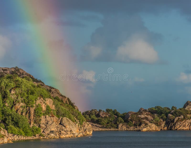 Intense Rainbow Rising Above Cliffs Stock Photo - Image of hill ...