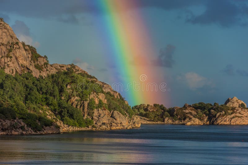 Intense Rainbow Rising Above Cliffs Stock Image - Image of summer ...