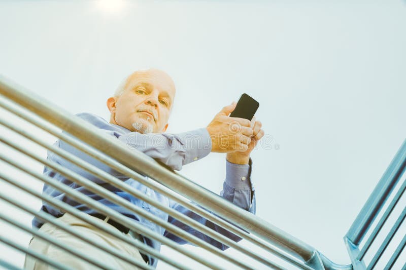 Intense Smartphone Use, Man at Metal Railing Stock Photo - Image of ...
