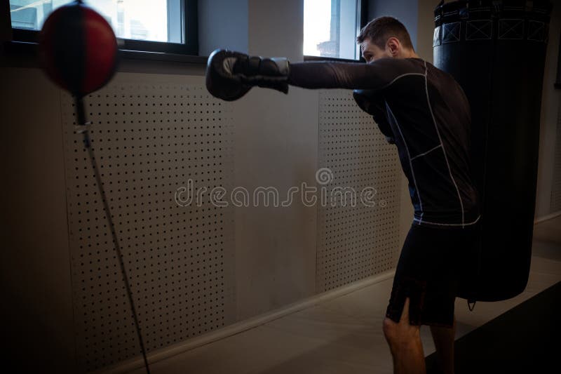 Intense Workout of Boxer Practicing on Floor-to-ceiling Bag in Gym ...
