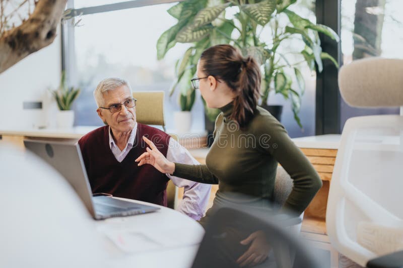Creative, Cross Generational Business Coworkers Collaborating on a ... Creative, Cross Generational Business Coworkers Collaborating on a ...