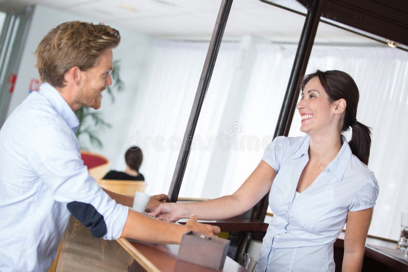 Interaction at front desk stock image. Image of client - 173913797