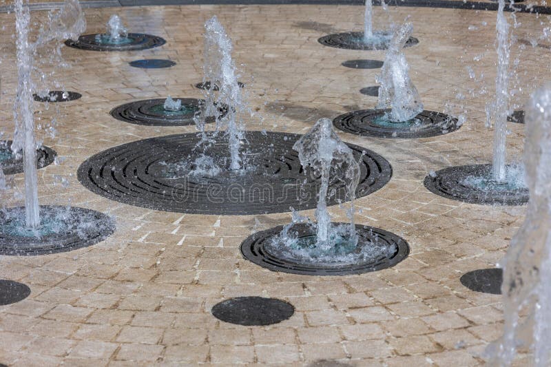 Interactive Circular Water Fountain with Bubbling Jets on Paved Surface ...