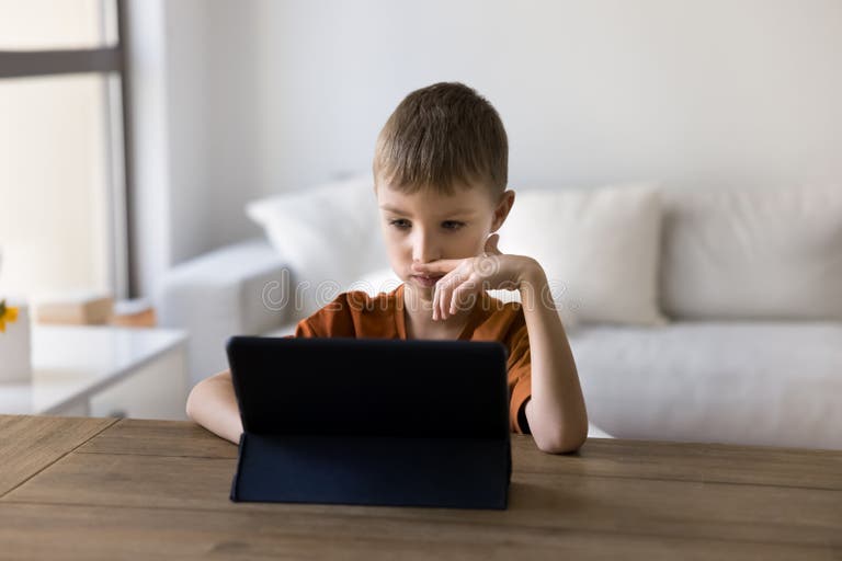 Focused Young Kid Schoolboy Study from Home Using Tablet Computer Stock ...