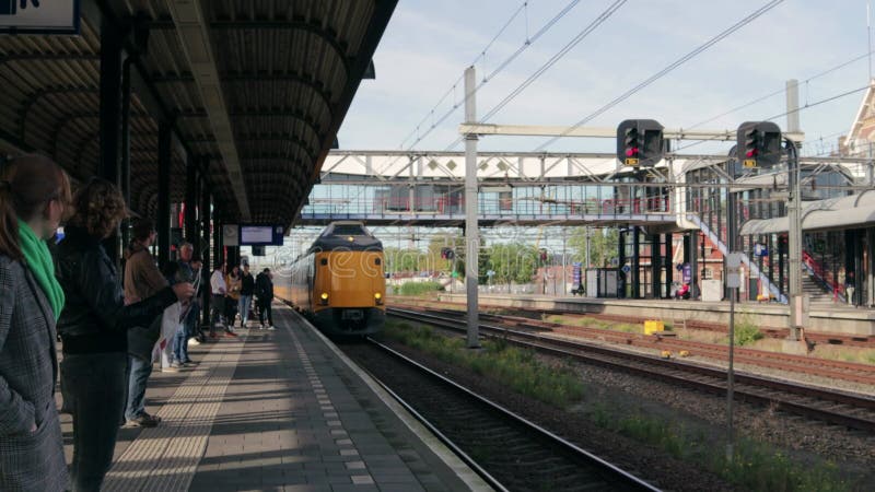 Intercity Train Pulling into Station beside Outdoor Platform with ...