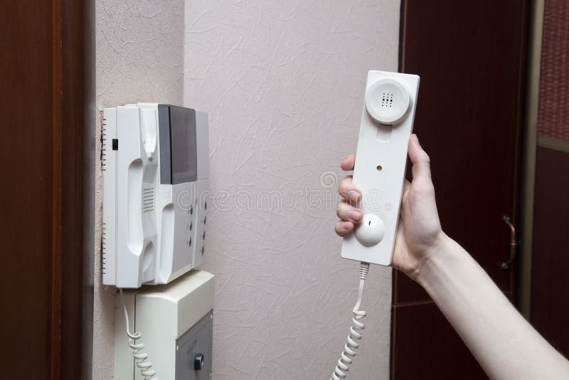 Intercom.a Man Uses an Intercom To Communicate with Guests Stock Photo ...