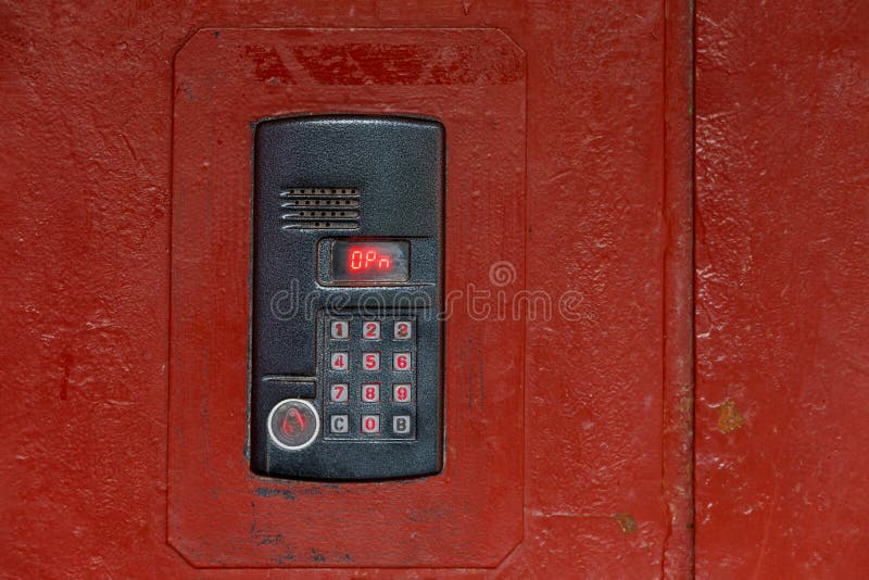 An Intercom on Old Painted Red Steel Surface with a Keypad, Digital ...