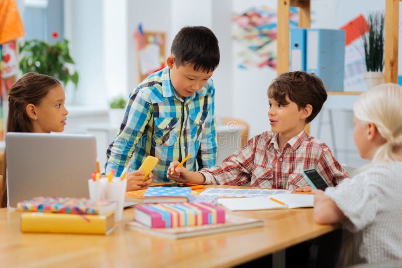 Interested Children Discussing School Issues Together in a Classroom ... Interested Children Discussing School Issues Together in a Classroom ...