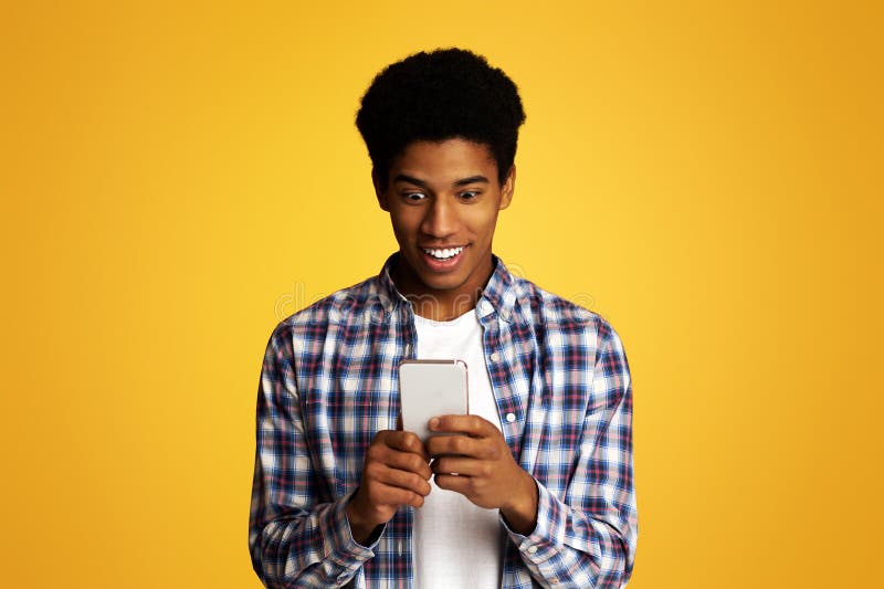 Interested Guy Using Smartphone on Yellow Background Stock Photo ...
