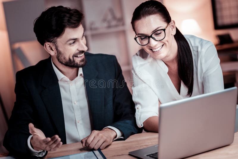 Interested Responsible Colleagues Smiling and Using the Laptop. Stock ...