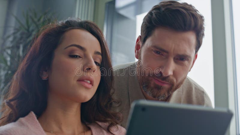 Interested Spouses Watching Tablet Computer Talking Together at Kitchen ...