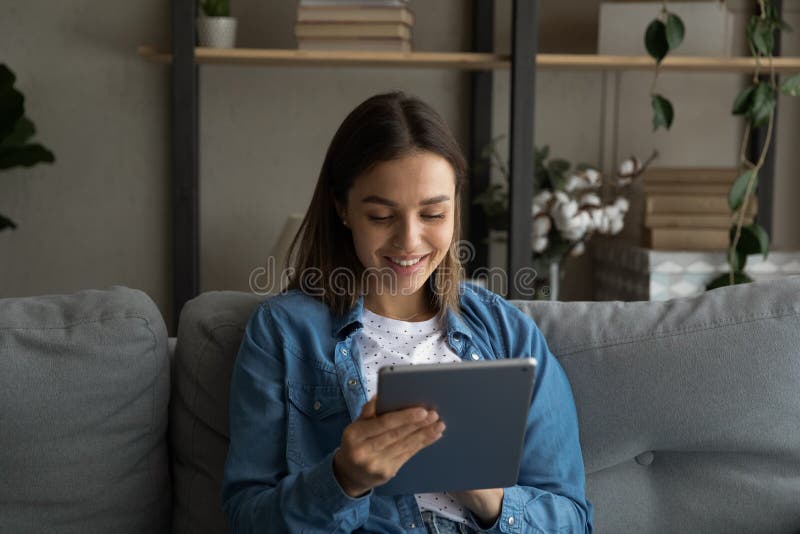 Interested Teen Female Reading Electronic Version of Book on Tablet ...