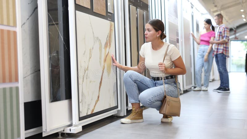 Interested Young Female Customer Browsing Tile Samples on Display Stand ...