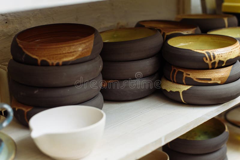 Interesting Handmade Ceramic Plates on the Shelf of the Potter`s ...