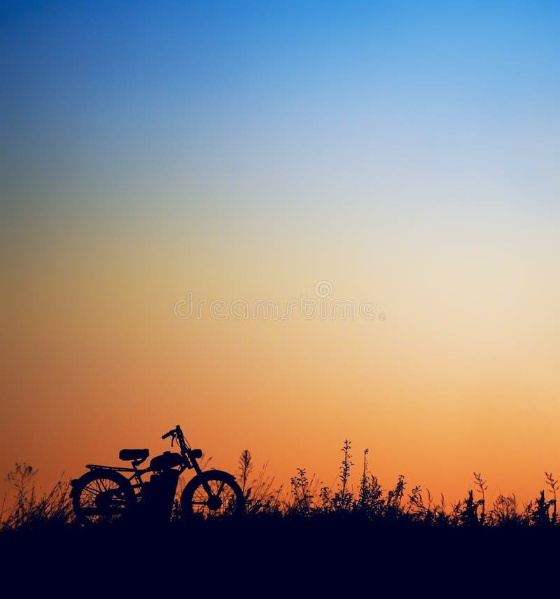 An Interesting Silhouette of a Motorcycle and Grass at Sunset Stock ...