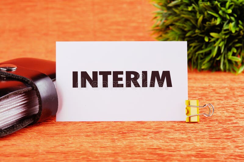 Interim Writing on a White Card on an Orange Background, Close-up ...