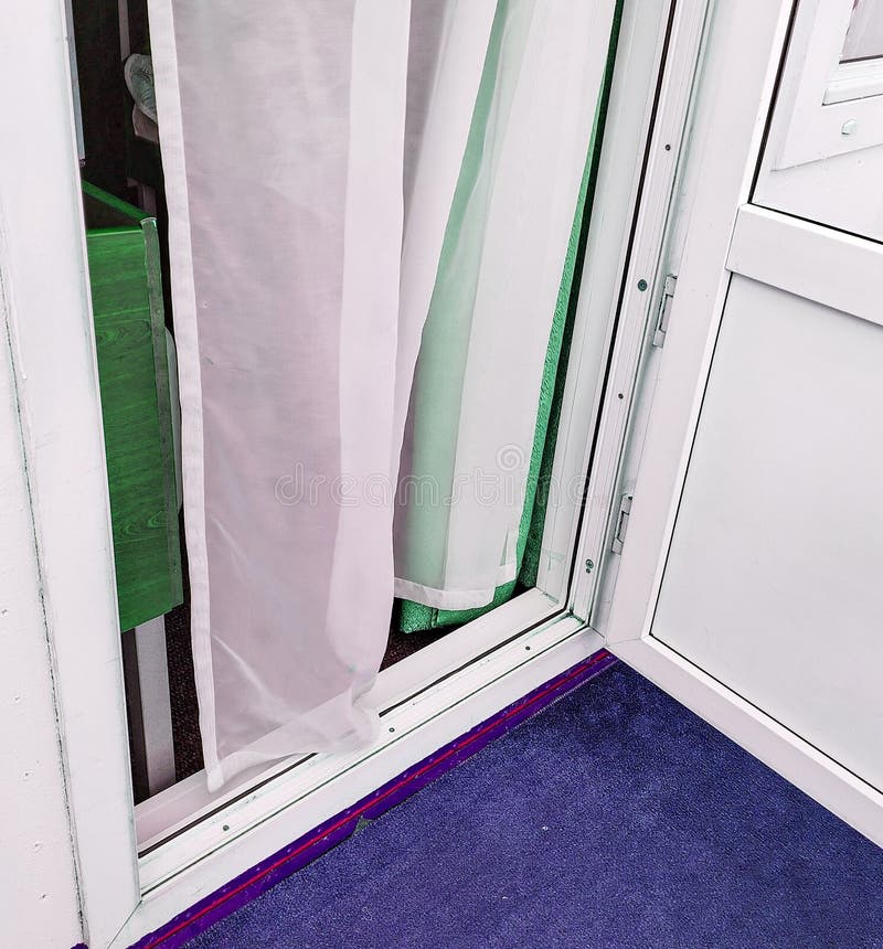 The Interior of the Balcony with an Open White Plastic Door and ...