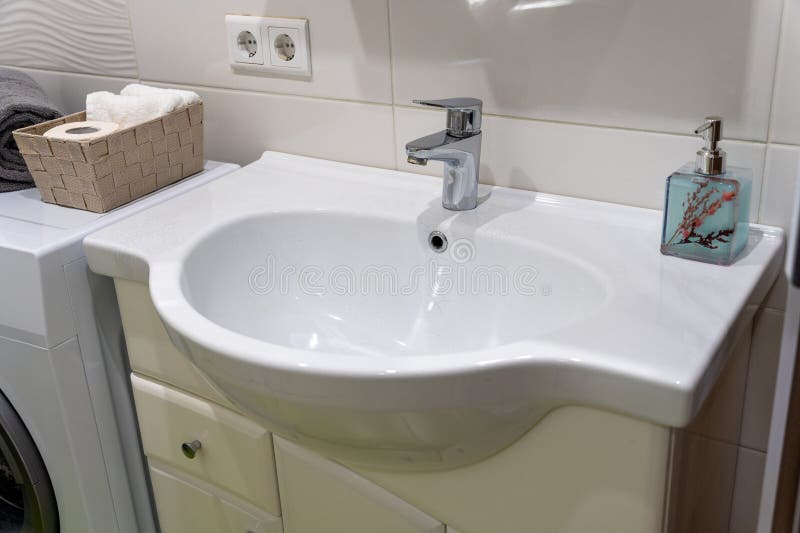 Interior of Bathroom with White Sink and Washing Machine Stock Photo ...