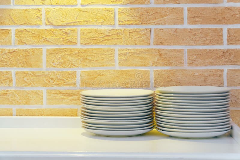Interior with Brick Wall Chest of Drawers and a Stack of Plates Stock ...