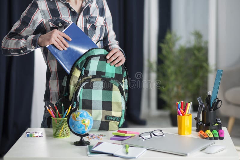 The Student Takes a Notebook from His Backpack Stock Photo - Image of ...