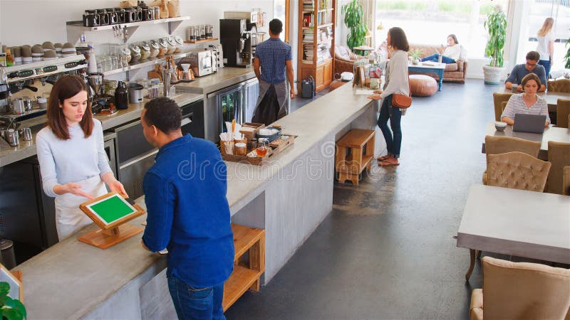 Interior of Busy Cafe or Coffee Shop with Staff Serving Customers at ...