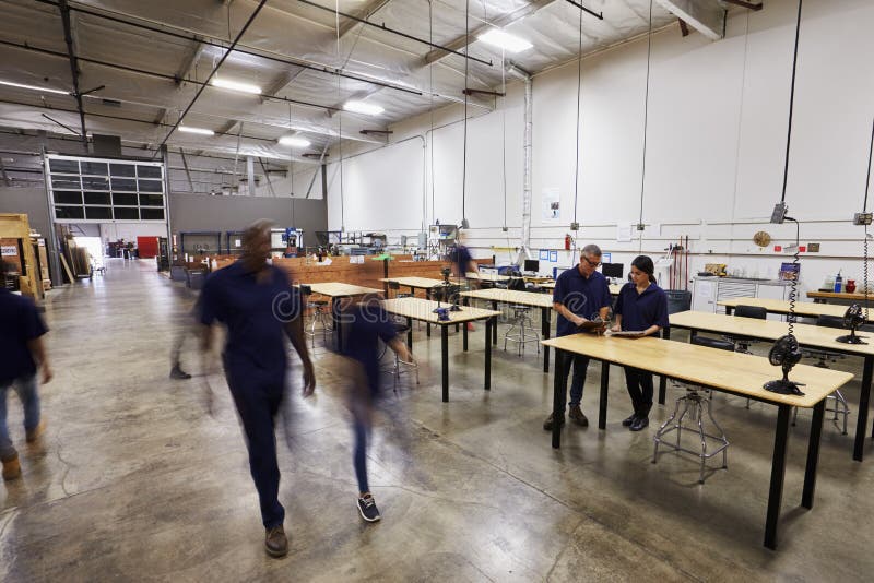 Interior of Busy Factory with Staff at Work Benches Stock Photo - Image ...