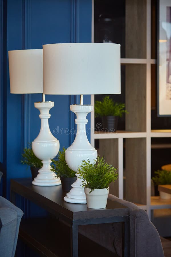 Interior Decor. Two Large White Table Lamps with Large Shades in a Dark ...