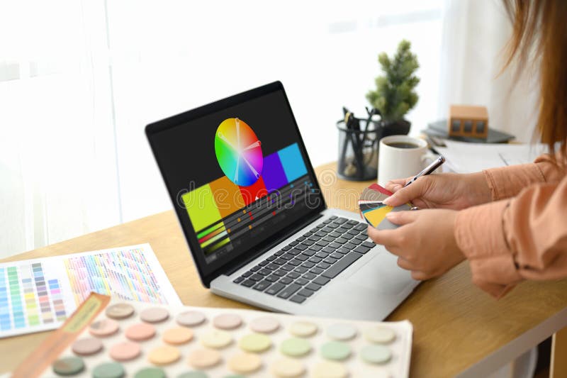 Interior Designer Reviewing Color Palettes and Design Samples while ...