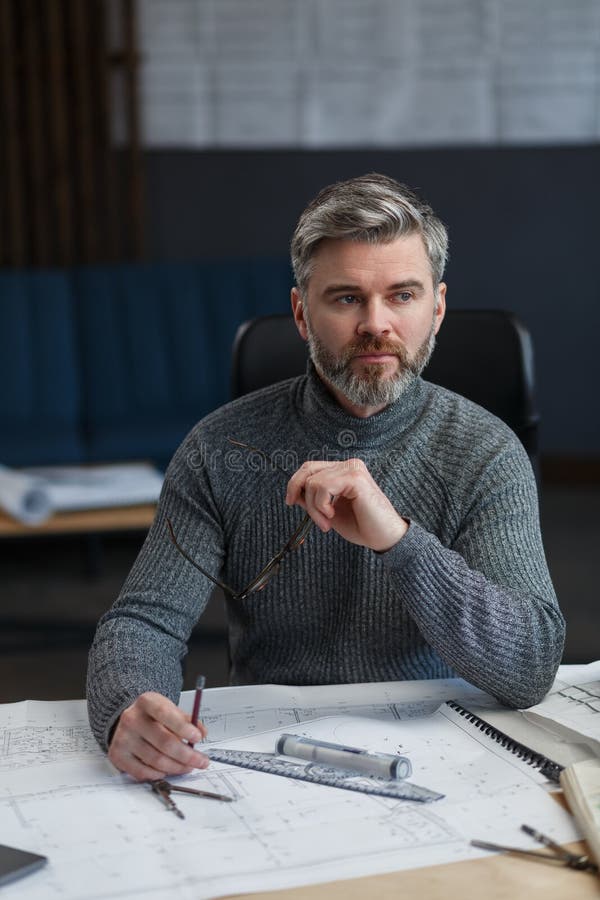 Interior Designer Working In Office With Blueprints.Engineer Inspect ...