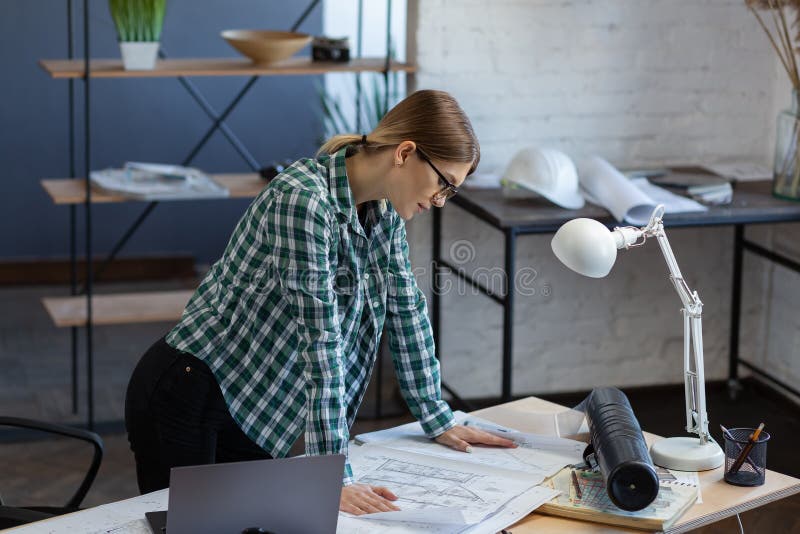 Interior Designer Working in Office with Blueprints.Engineer Inspect ...