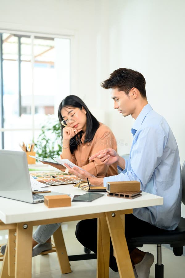 Interior Designers Collaborating on a Project, Reviewing Material ...