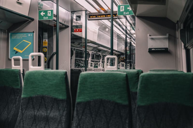 Interior of an Empty Modern Train with Green Seats and Exit Signs ...