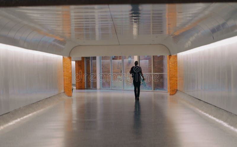Interior Hallway Featuring a Human Figure Walking through it Stock ...