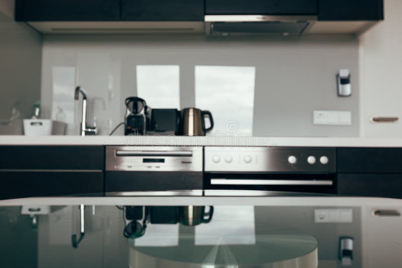 Interior of a Kitchen. Focus in Front on the Glass Table with Blurred ...