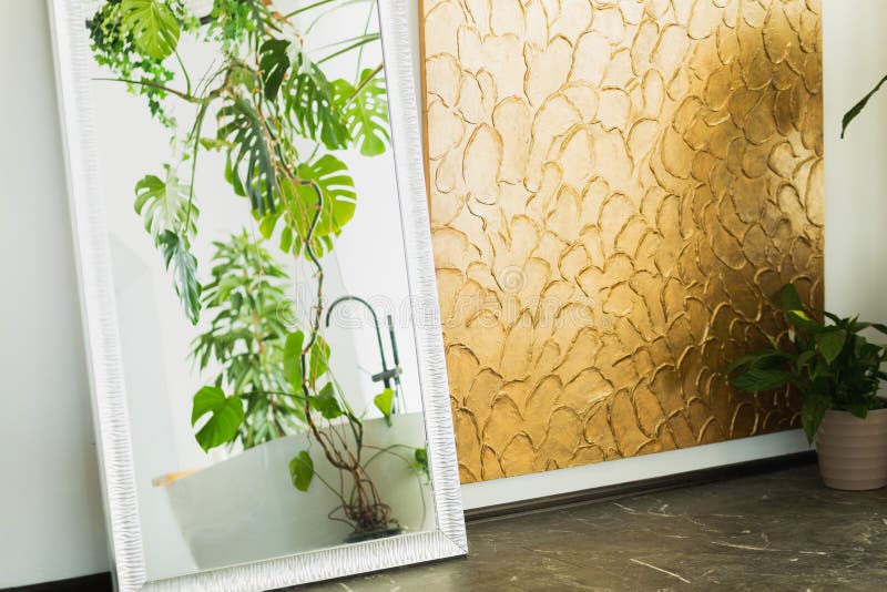 Interior: a Large Mirror that Reflects Part of the Bath and Plants ...