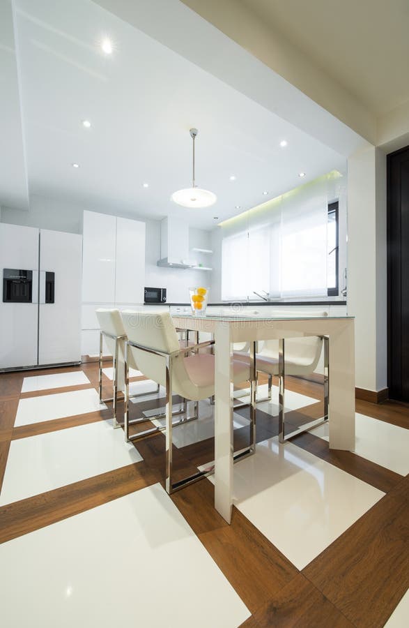 Interior of a Modern Luxury Bright White Kitchen with Dining Tab Stock ...