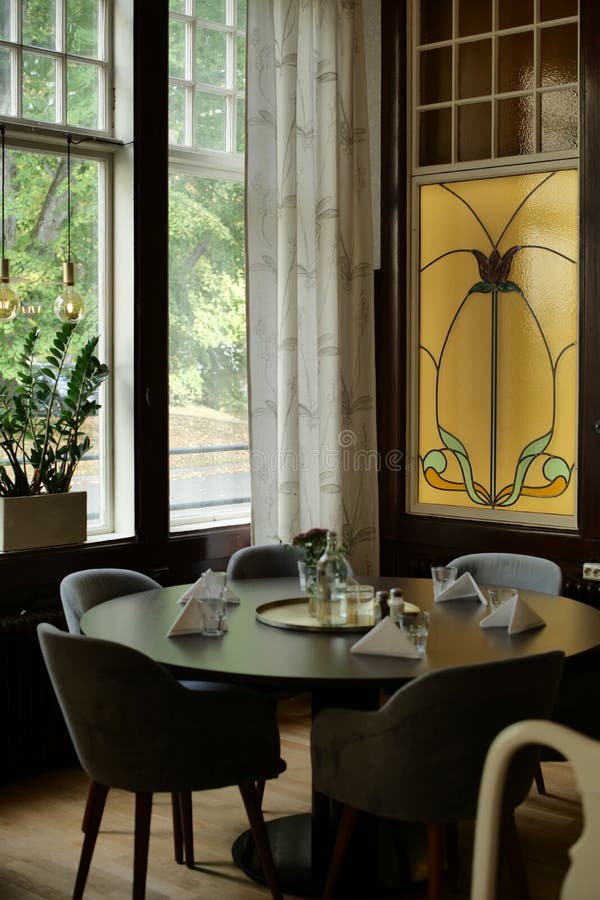 Interior of Modern Restaurant with Black Chairs Around Black Round ...