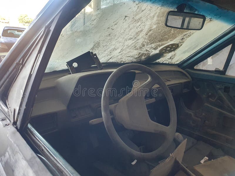 The Interior of an Old Car, with Dusty Steering Wheel, Dashboard and ...