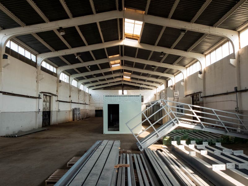 Interior of the Old Warehouse with Piled Construction Materials Stock ...