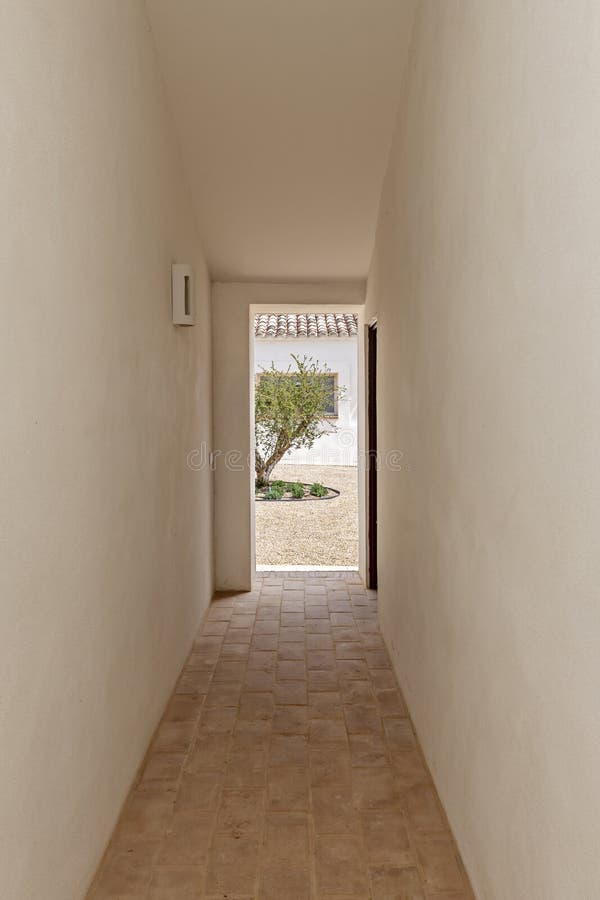 Interior Passageway with Smooth Walls and Terracotta Floors Overlooking ...