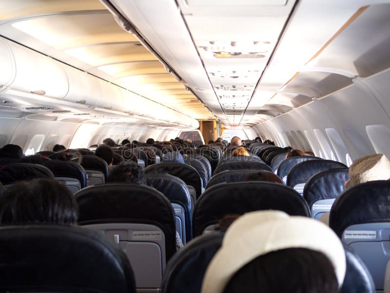 Interior of a Plane with Passengers on Their Seats Editorial Stock ...