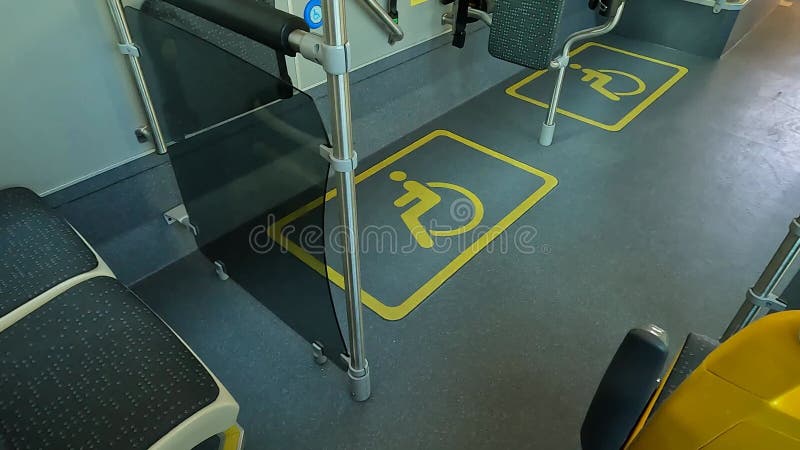 Interior of a Public Bus with Designated Seating for Disabled and ...